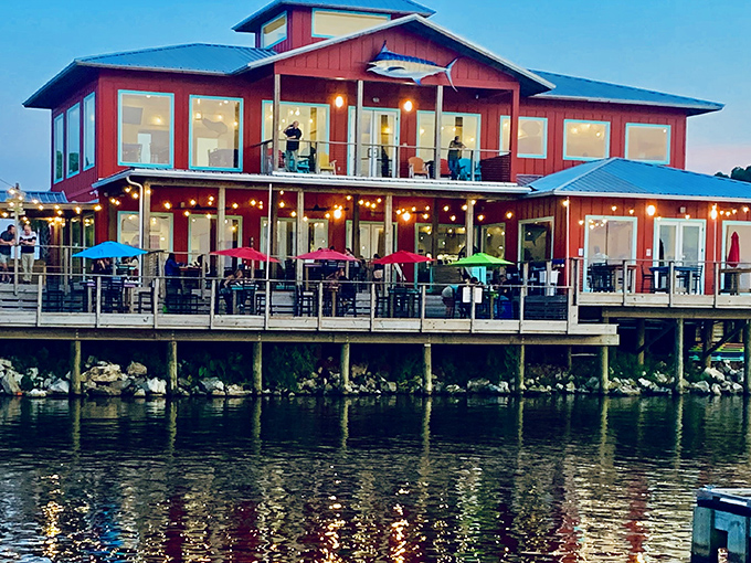 The vibrant red exterior of Shaggy's stands out like a cheerful beacon, promising coastal delights with palm trees that whisper, "Vacation starts here."