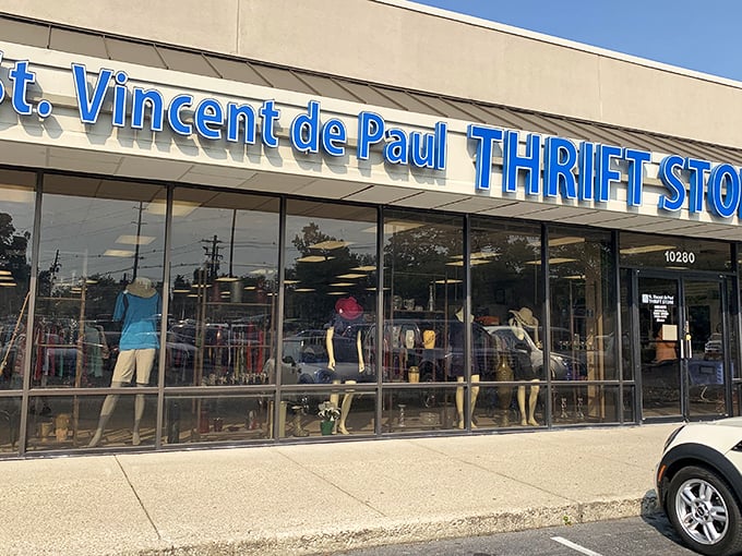 The blue signage of St. Vincent de Paul beckons like a thrift store lighthouse, promising treasures within those glass doors.