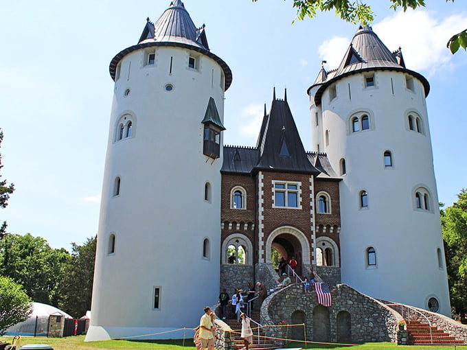 The majestic exterior of Castle Gwynn stands proudly against the Tennessee sky, its white towers a startling medieval vision in the Southern landscape.