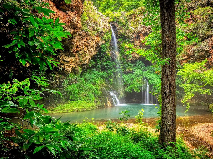 Nature's perfect curtain call &ndash; water cascades over a wide ledge, creating a serene backdrop that makes even smartphone photographers look like Ansel Adams.