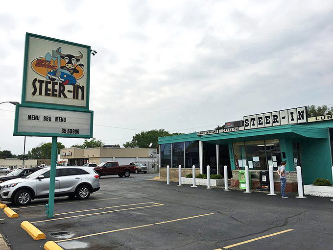 The turquoise beacon of Steer-In stands proudly against an Indiana sky, promising comfort food salvation to hungry Indianapolis souls.