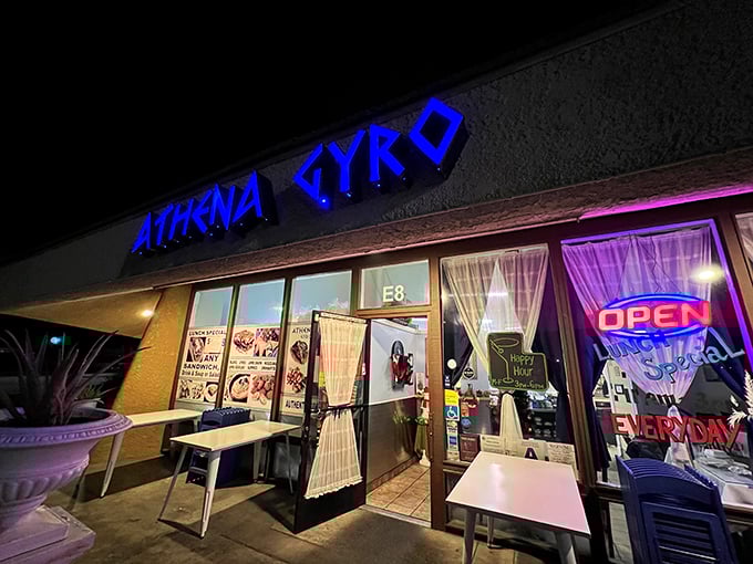 The blue glow of Athena Gyro's sign beckons like a Mediterranean lighthouse in the desert night, promising authentic Greek flavors behind those welcoming doors.