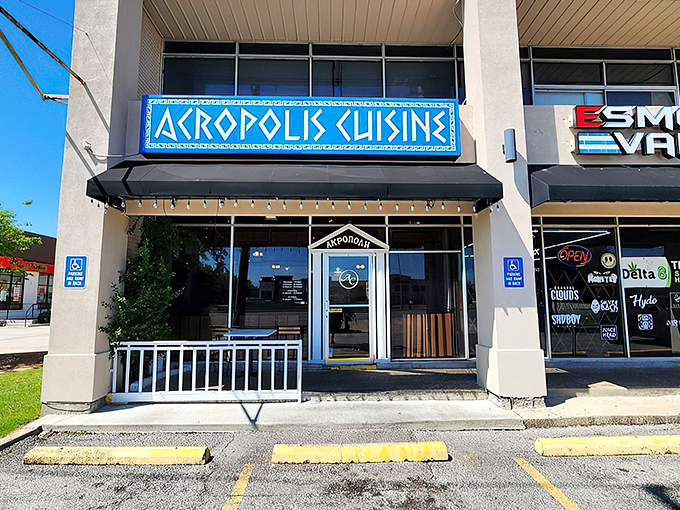 The bright blue sign of Acropolis Greek Cafe stands out like a Mediterranean beacon in Metairie, promising authentic Greek flavors just steps away.