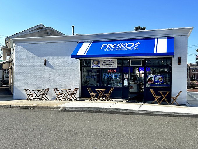 The iconic blue awning of Freskos stands out like a beacon of Mediterranean promise, complete with sunny outdoor seating for those perfect Connecticut afternoons.