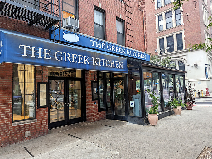 The blue awning of The Greek Kitchen beckons like a Mediterranean oasis amid Manhattan's brick landscape. Your Aegean adventure awaits!