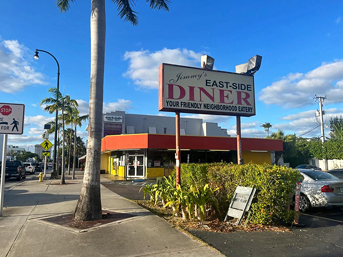 The iconic red and yellow exterior of Jimmy's Eastside Diner stands as a beacon of breakfast hope amid Miami's palm trees and sunshine.