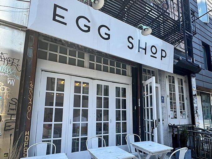 The minimalist white storefront of Egg Shop beckons like a breakfast beacon on Elizabeth Street, promising eggy delights within those French doors.