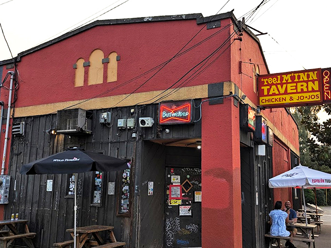 The unassuming red exterior of Reel M Inn stands like a culinary speakeasy, its vintage sign promising the holy trinity of dive bar perfection: chicken, jojos, and cold beer.
