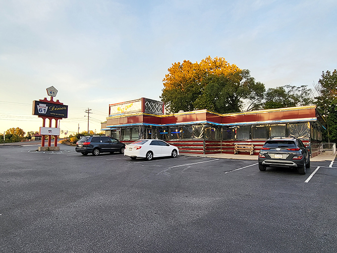 The classic roadside silhouette of Route 61 Diner stands against an autumn sky, beckoning hungry travelers like a neon-lit lighthouse for the famished.