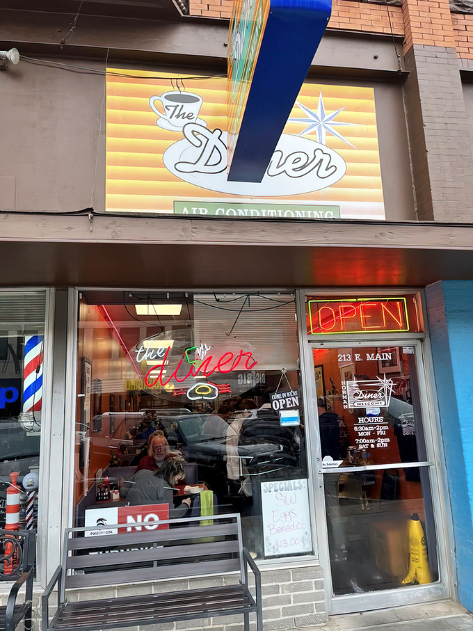 That vintage orange and teal sign isn't just advertising air conditioning&mdash;it's promising a time machine to when breakfast was an event worth getting dressed for.