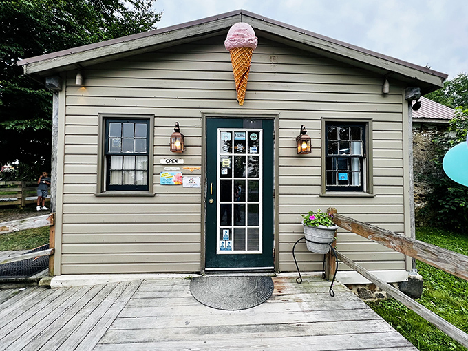The farmhouse charm of Woodside Farm Creamery beckons like an ice cream siren, with its stone wall and iconic cone sign promising dairy delights within.