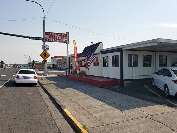 The classic red and white sign beckons like a lighthouse for hungry travelers. Mom and Pop's Diner isn't just a place&mdash;it's a promise of comfort ahead.