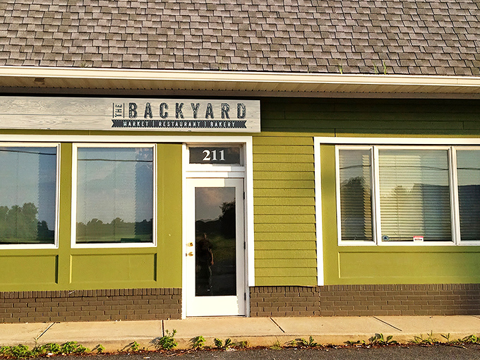The modest lime-green exterior of The Backyard hides culinary treasures within, proving you should never judge a restaurant by its siding.