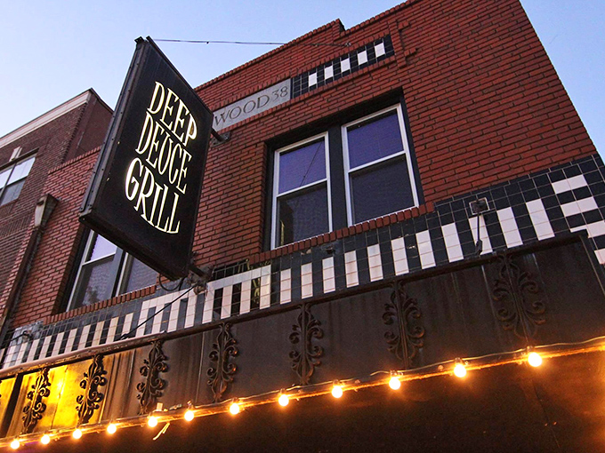 The iconic Deep Deuce Grill sign beckons hungry travelers like a lighthouse for comfort food. Those string lights aren't just decoration&mdash;they're a promise of good things to come.