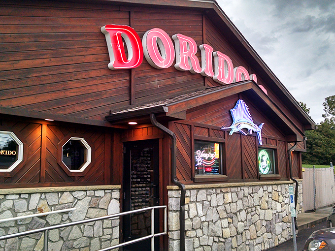 The glowing red Dorido's sign against rustic wood paneling promises seafood salvation in Pittsburgh's concrete jungle. Maritime magic awaits!