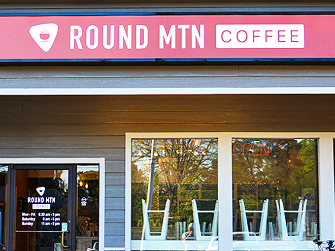 That distinctive orange sign beckons like a lighthouse for the caffeine-deprived, promising salvation in a cup just beyond those welcoming doors.