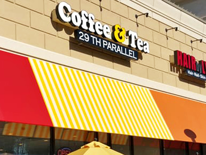 The unassuming storefront hides coffee greatness like a superhero's secret identity. Green signage and simple exterior belie the caffeinated magic happening inside.