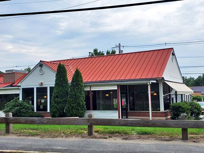 The iconic Vic's Waffle House sign stands tall against the Massachusetts sky, beckoning hungry travelers with promises of breakfast bliss and maple-drenched dreams. 