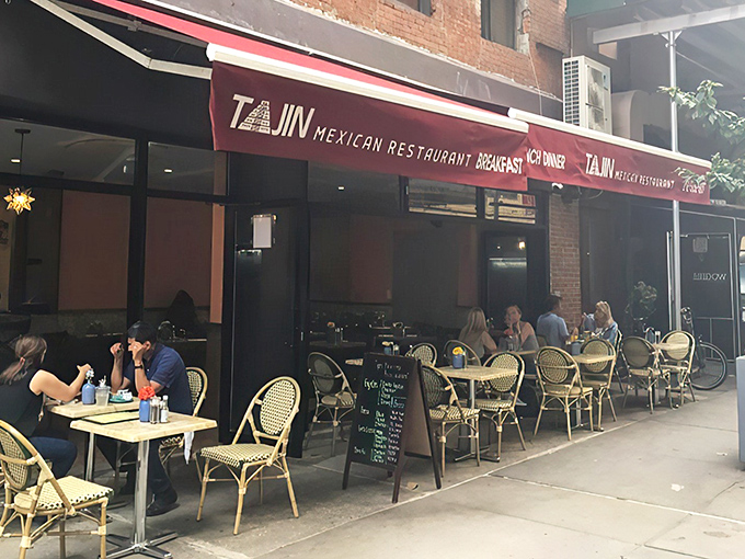 The crimson awning of Tajin beckons like a culinary lighthouse in the urban sea, promising authentic Mexican flavors behind those welcoming doors.
