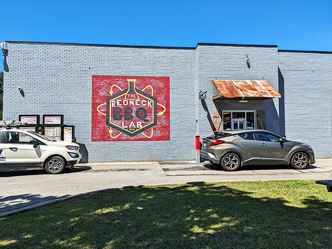 The white brick exterior with bold red and yellow signage announces what you're in for: serious barbecue wrapped in a playful scientific package.