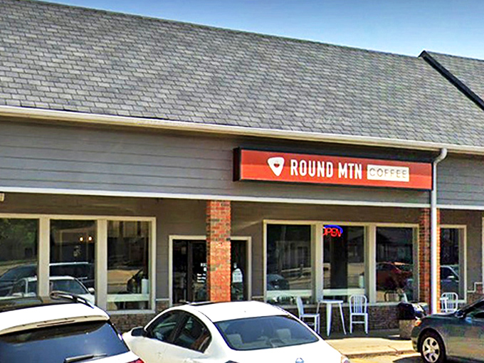 That distinctive orange sign beckons like a lighthouse for the caffeine-deprived, promising salvation in a cup just beyond those welcoming doors.