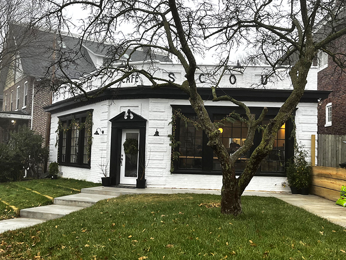 Scout Cafe's charming white brick exterior stands like a coffee oasis in Wilmington's Forty Acres neighborhood, promising caffeinated treasures within.