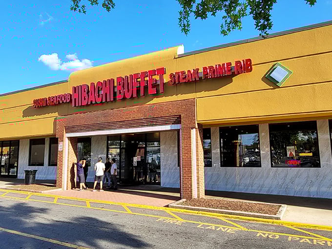 The golden-yellow exterior of Hibachi Buffet beckons like a beacon of culinary abundance on Buford Highway, with its bold red lettering promising seafood, steak, and prime rib adventures within.