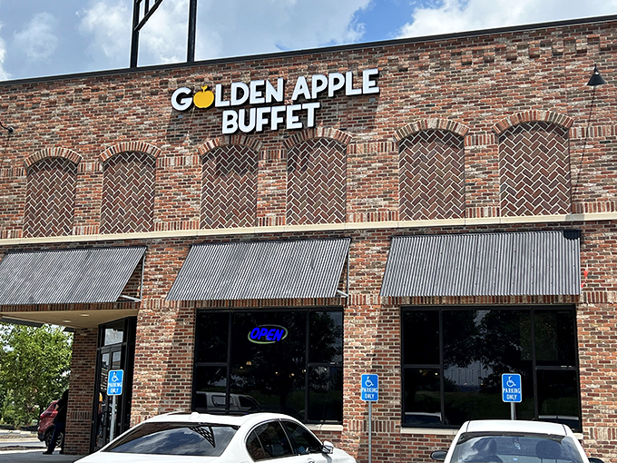 The brick facade of Golden Apple Buffet stands like a temple to abundance, promising culinary adventures behind those metal-awninged windows.