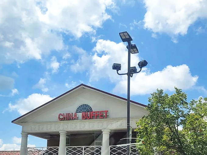 The stately white columns of China Buffet stand proudly against the blue sky, like a temple dedicated to the worship of all-you-can-eat delights.