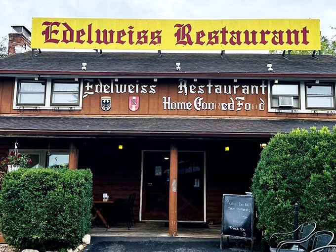 The rustic log cabin exterior of Edelweiss Restaurant promises Bavarian delights beneath stormy skies. Like finding a German postcard come to life in Virginia's Shenandoah Valley.