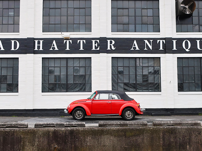 A classic red Volkswagen Beetle parked outside Mad Hatter's striking white facade&mdash;like a cherry on top of this multi-layered sundae of nostalgia. 