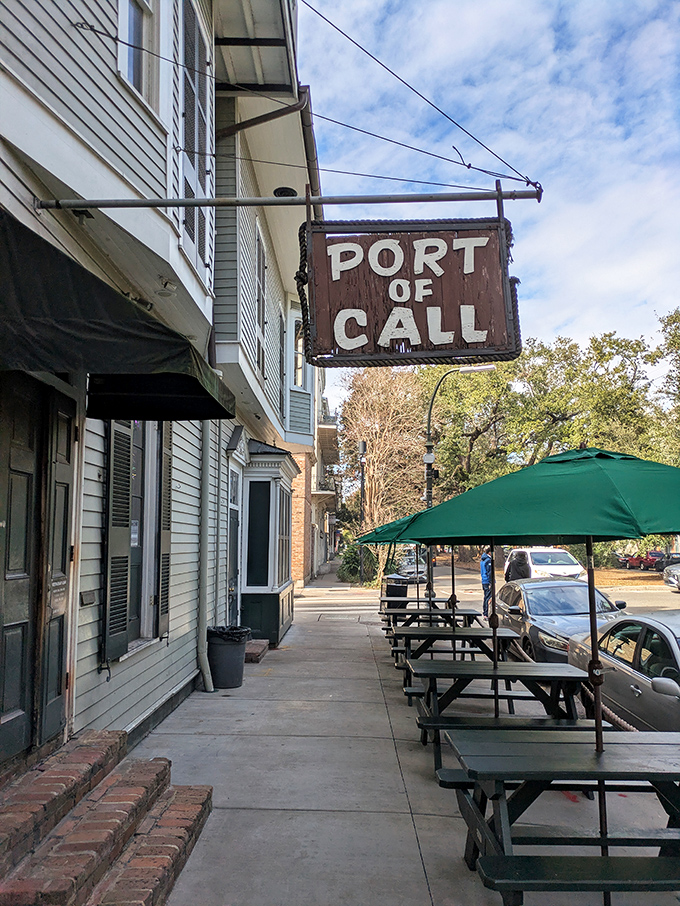 The unassuming exterior hides culinary greatness, with Port of Call's wooden sign swinging gently like a maritime invitation to burger paradise.