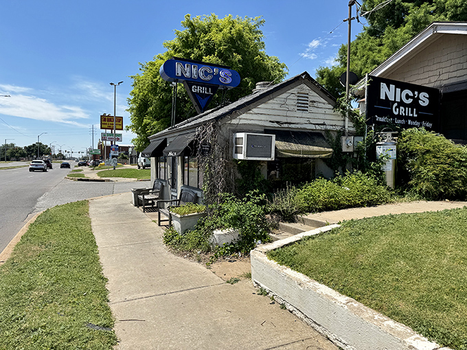 The unassuming exterior of Nic's Grill looks like any other house on the block—until you spot that sign promising burger nirvana inside.