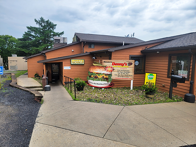 The unassuming wooden exterior of Denny's Beer Barrel Pub &ndash; where burger legends are born and diets go to die. 