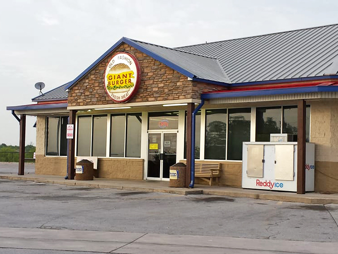 The stone facade and iconic circular sign promise what lies within: burger nirvana waiting just off the highway.