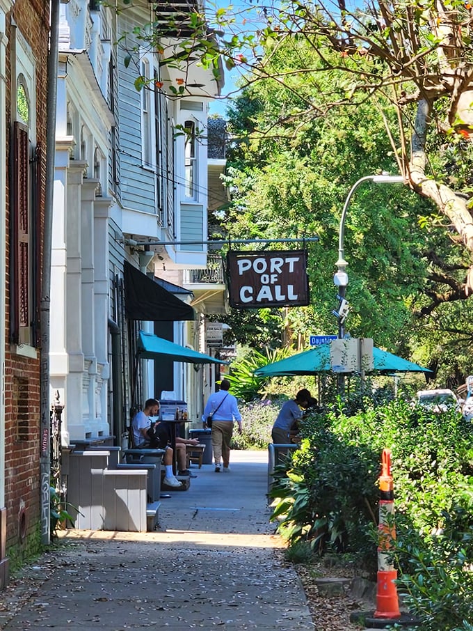 The unassuming exterior hides culinary greatness, with Port of Call's wooden sign swinging gently like a maritime invitation to burger paradise.