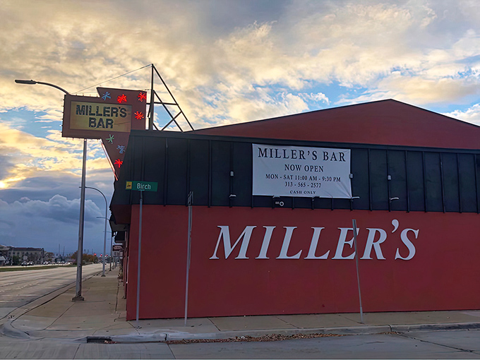 The iconic red sign at Miller's Bar stands like a beacon of burger hope at the corner of Michigan and Birch in Dearborn.