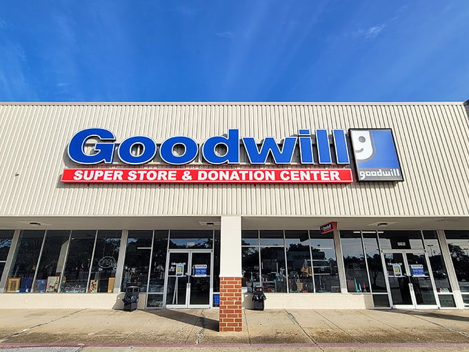 The curved facade of Goodwill's Super Store in Biloxi beckons like a blue-signed beacon of bargain possibilities, promising treasures waiting to be discovered inside.