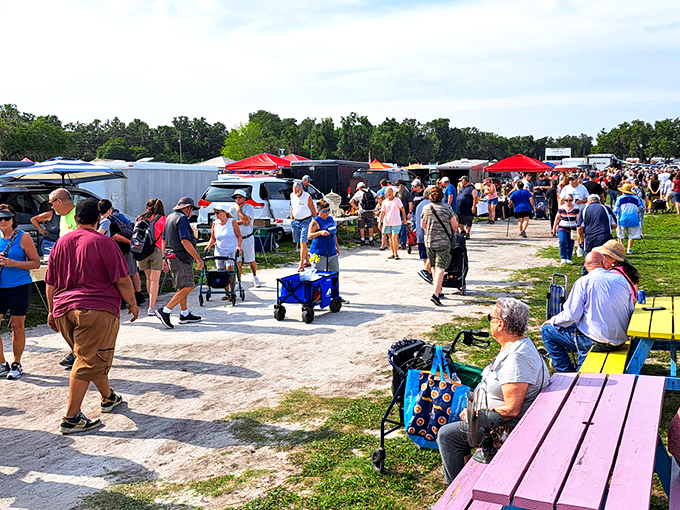 The market's main thoroughfare buzzes with activity as shoppers scan tables on both sides. Veterans know to check the corners&mdash;that's where the real treasures hide.