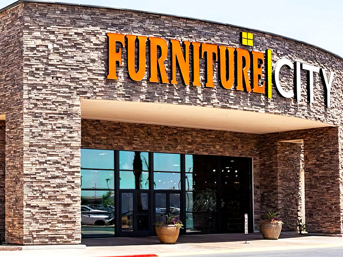 The grand entrance to Furniture City beckons with its impressive stone facade and bold signage&mdash;like the pearly gates of home decor heaven.