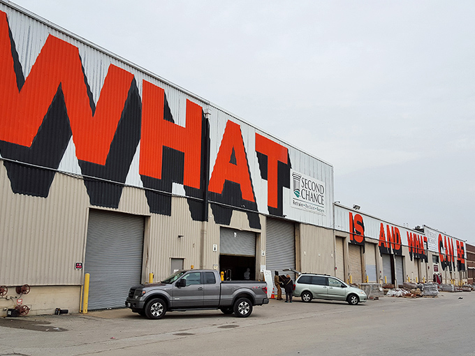 The warehouse with "WHAT" emblazoned across it isn't asking a question&mdash;it's making a statement about possibility and transformation.