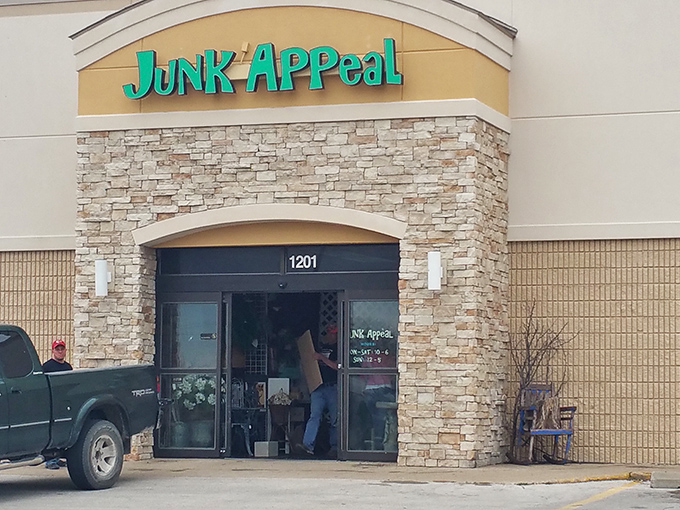The turquoise sign of Junk Appeal beckons like a siren call to bargain hunters. Behind that stone facade lies a wonderland of treasures waiting to be discovered.
