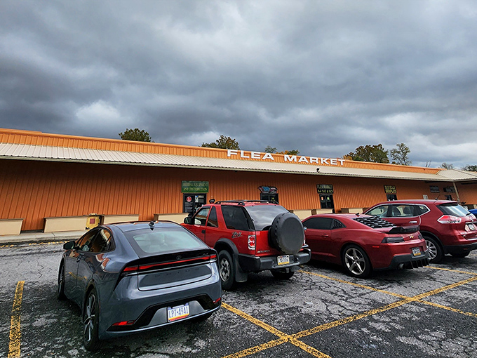 The unassuming orange exterior of Antique Depot stands like a treasure chest waiting to be opened, with storm clouds adding dramatic flair to your bargain-hunting adventure.