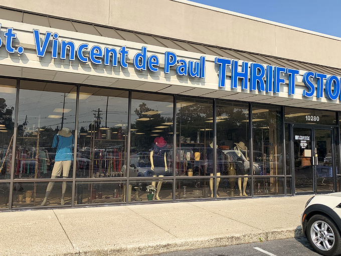 The blue signage of St. Vincent de Paul beckons like a thrift store lighthouse, promising treasures within those glass doors.