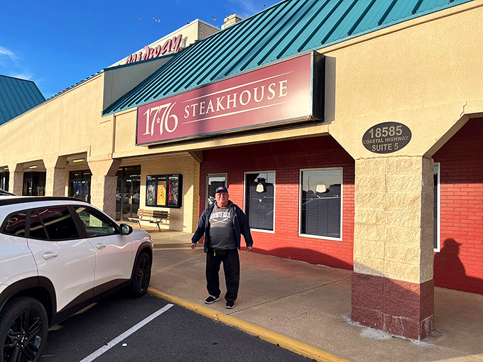 The bold red exterior of 1776 Steakhouse stands as a patriotic beacon for carnivores, promising revolutionary flavors behind those unassuming windows.