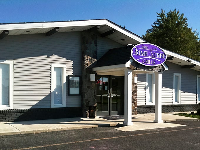 By day, The Prime Street Grille's purple sign stands as a modest beacon of culinary excellence in White Plains, promising steakhouse splendor behind its unassuming exterior.