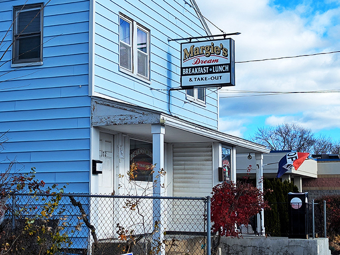 The iconic blue exterior of Margie's Dream Diner stands like a beacon of breakfast hope against the New Hampshire sky. Small building, big flavors.
