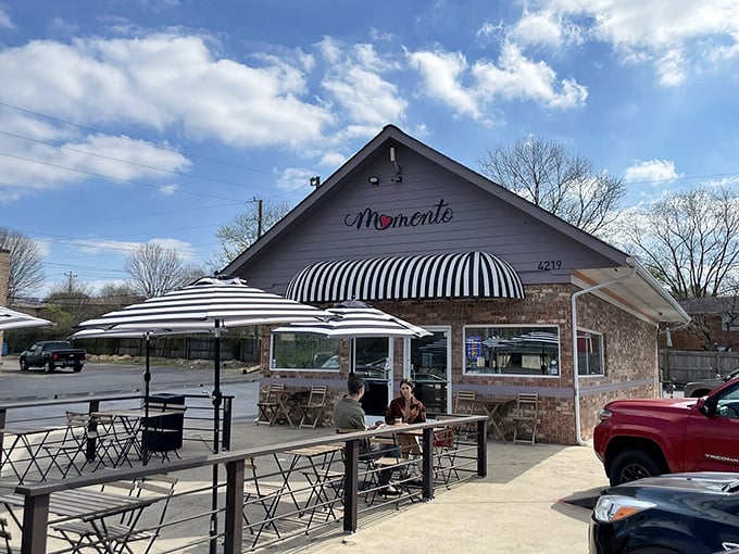 A brick cottage with a striped awning that whispers, "Come inside, we've got something special brewing." This charming exterior hides Tennessee's best-kept breakfast secret.
