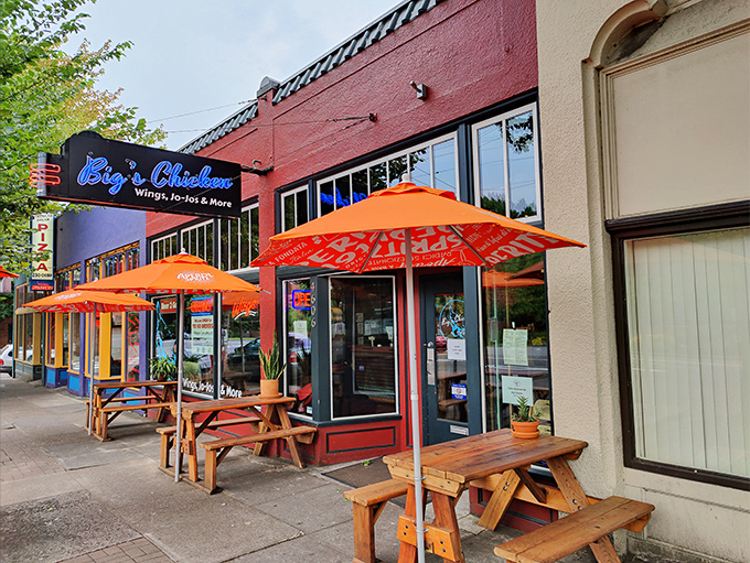 The vibrant red exterior with bright blue signage isn't just eye-catching&mdash;it's a beacon for chicken lovers seeking Portland's crispiest treasures. 