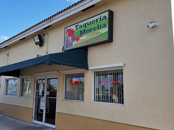 The unassuming exterior of Taqueria Morelia stands like a culinary speakeasy in Florida City, promising authentic flavors behind its modest fa&ccedil;ade.